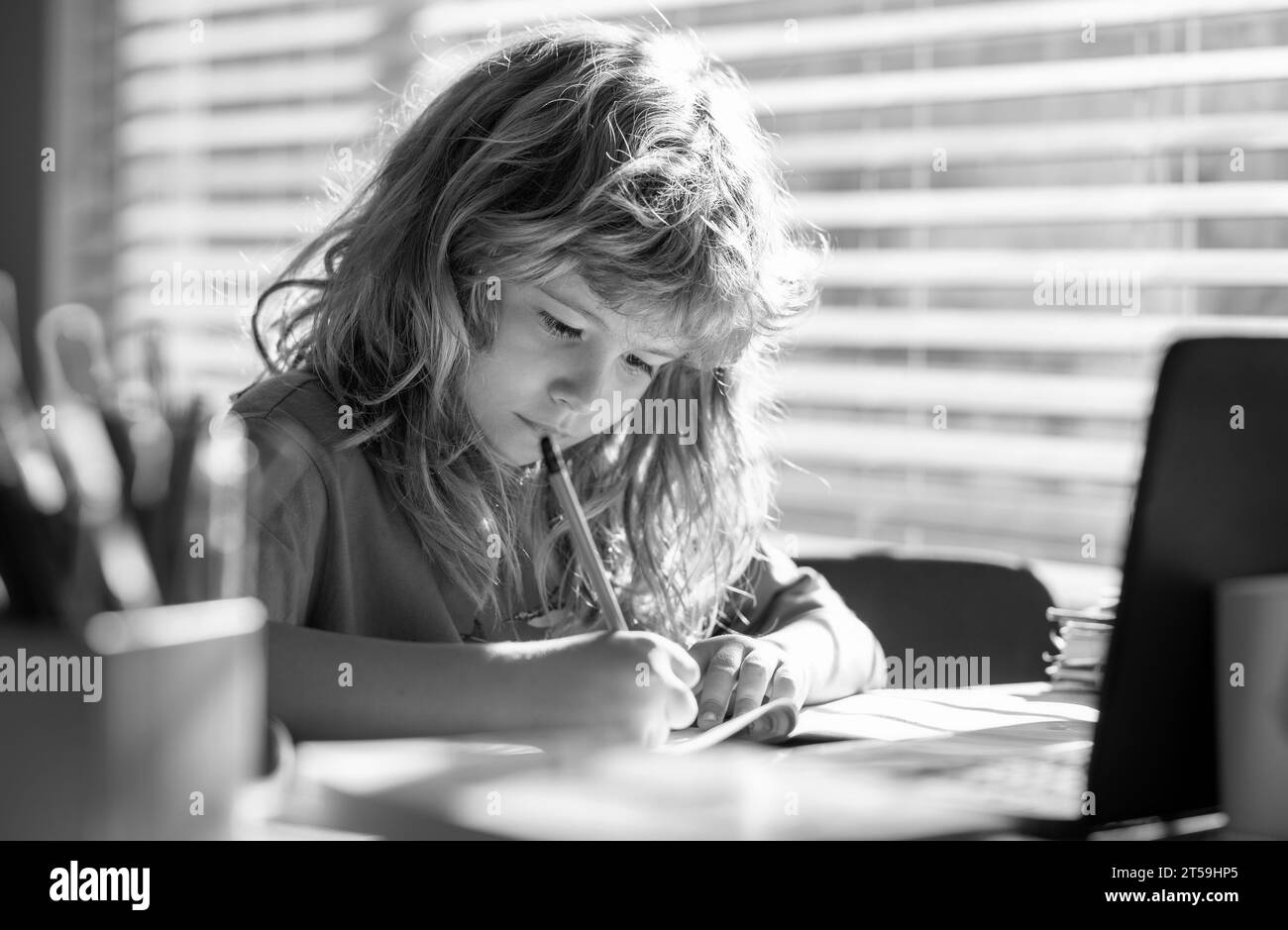Child writing at school. School boy making notes in copybook during ...