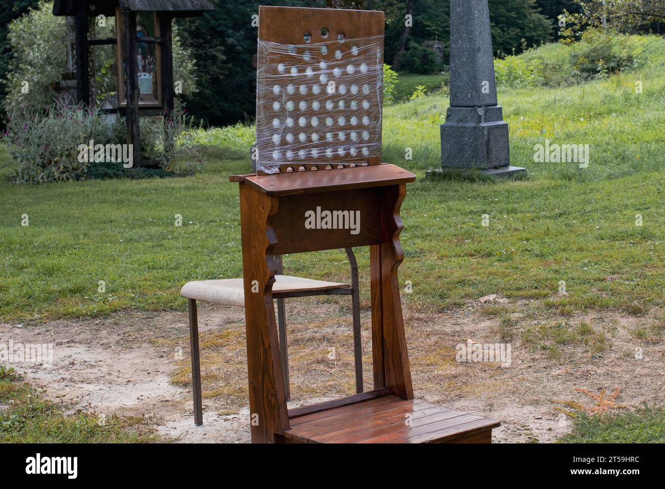 Confessional chair and kneeler with protective foil. Corpus cristi mass ...