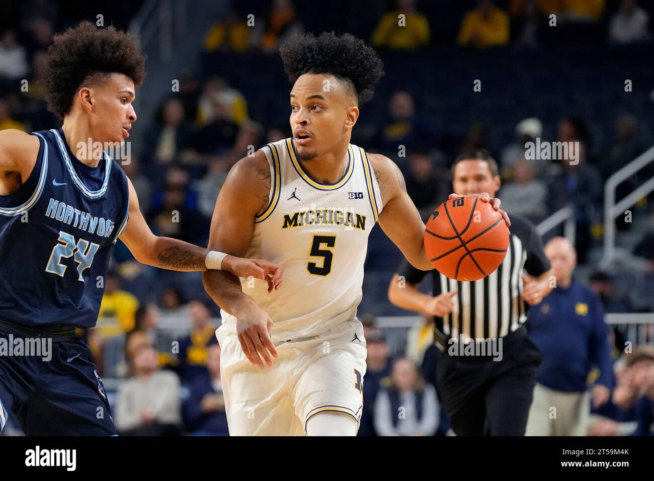 Michigan forward Terrance Williams II (5) brings the ball up court as ...