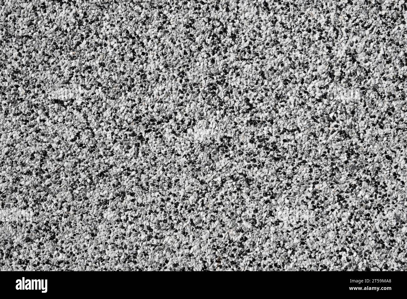 full-frame texture showcases the surface of granulite, displaying small ...