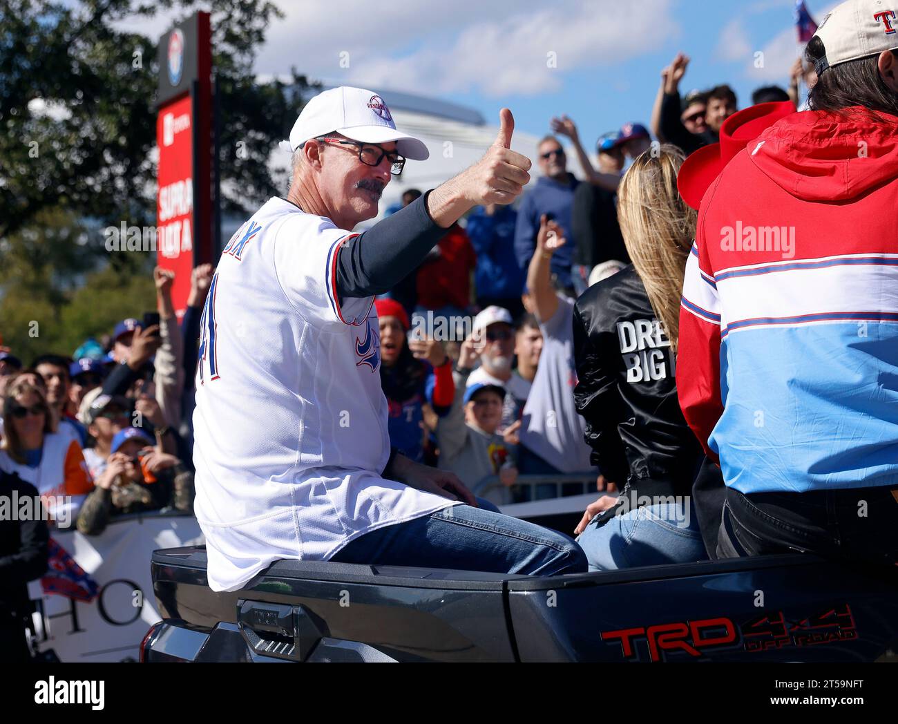 Texas Rangers pitching coach Mike Maddux gives a thumbs-up to fans ...