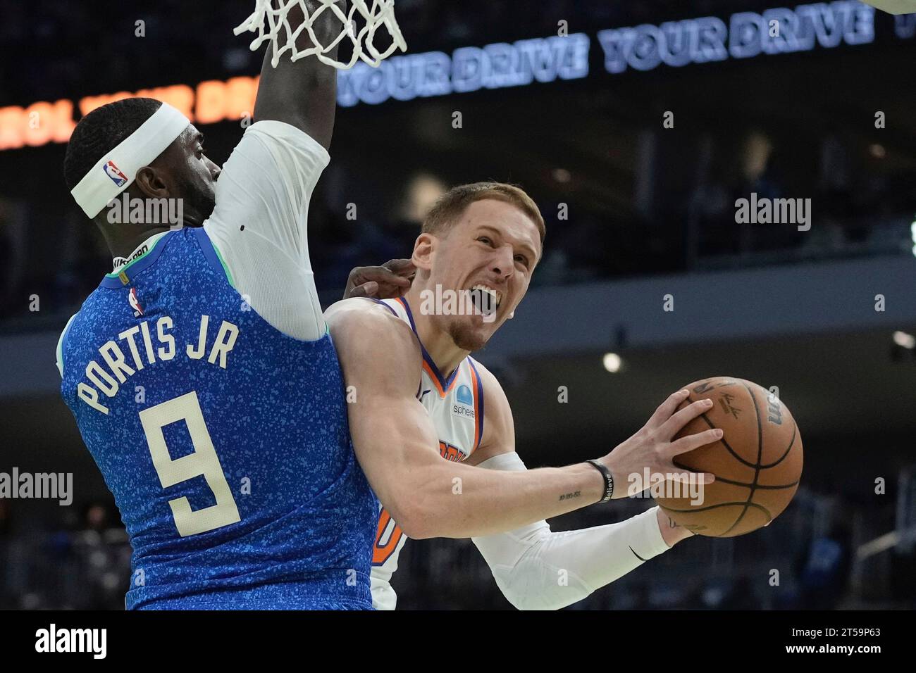 New York Knicks' Donte DiVincenzo tries to shoot around Milwaukee Bucks ...
