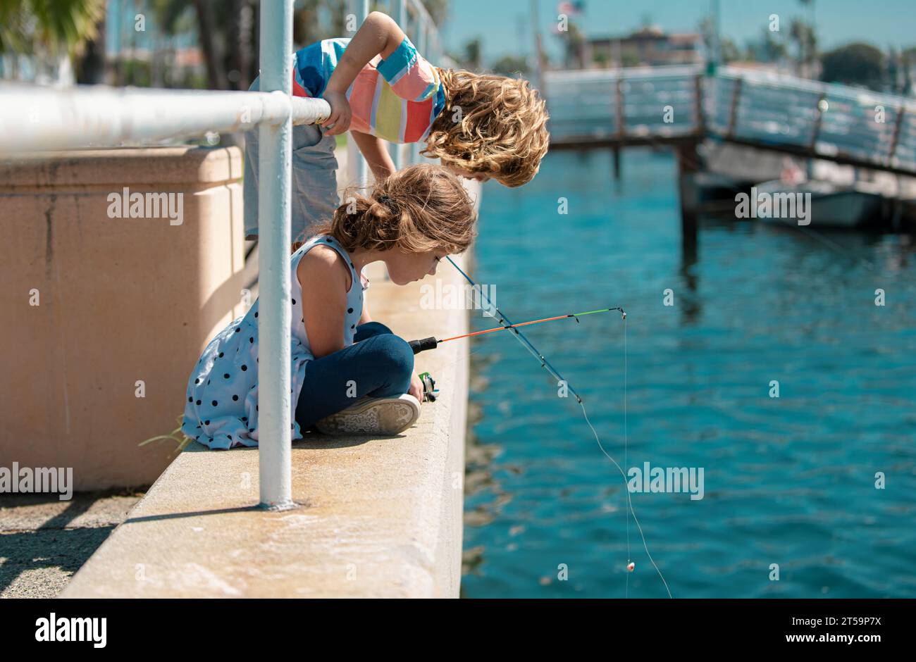Two kids boy and girl fishing in a river or lake. Happy excited ...
