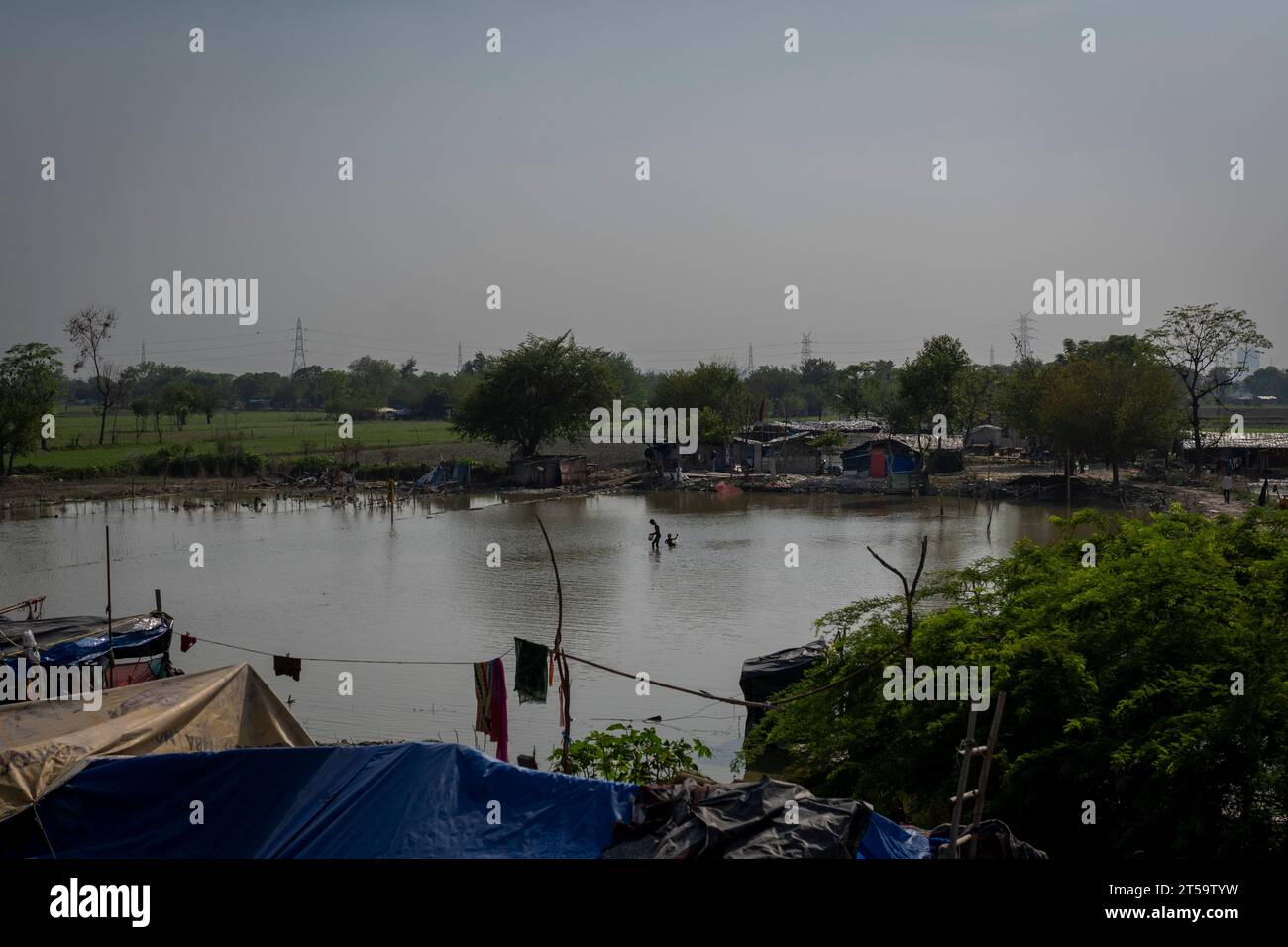 Boys, living in a settlement on the flood plain of Yamuna River, play ...