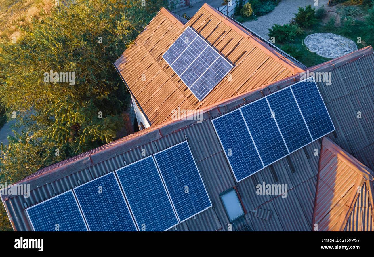 Photovoltaic modules on the roof of a house from different sides. Green ...