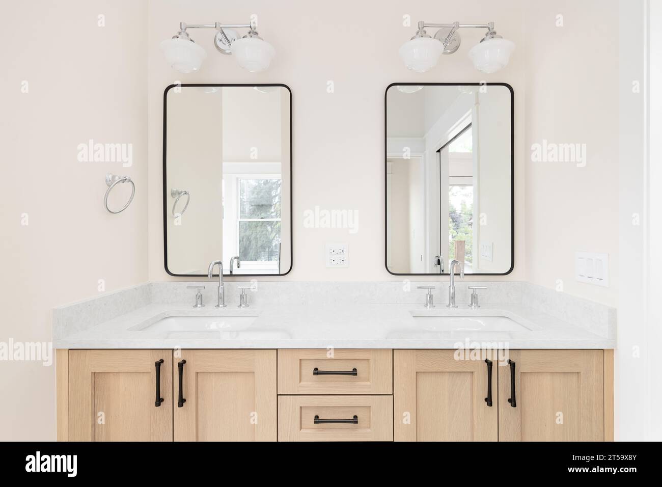 A cozy bathroom detail with a white oak vanity cabinet, marble ...