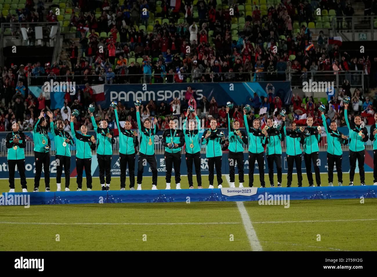 Team Mexico poses with their gold medals on the podium during a ...