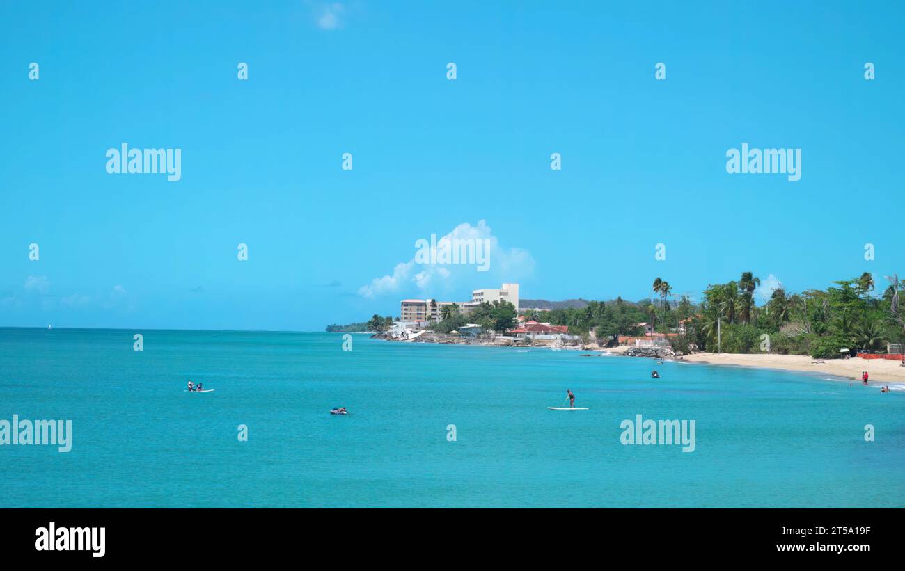 People enjoying water sports at Playa Los Almendros Rincon Puerto Rico ...