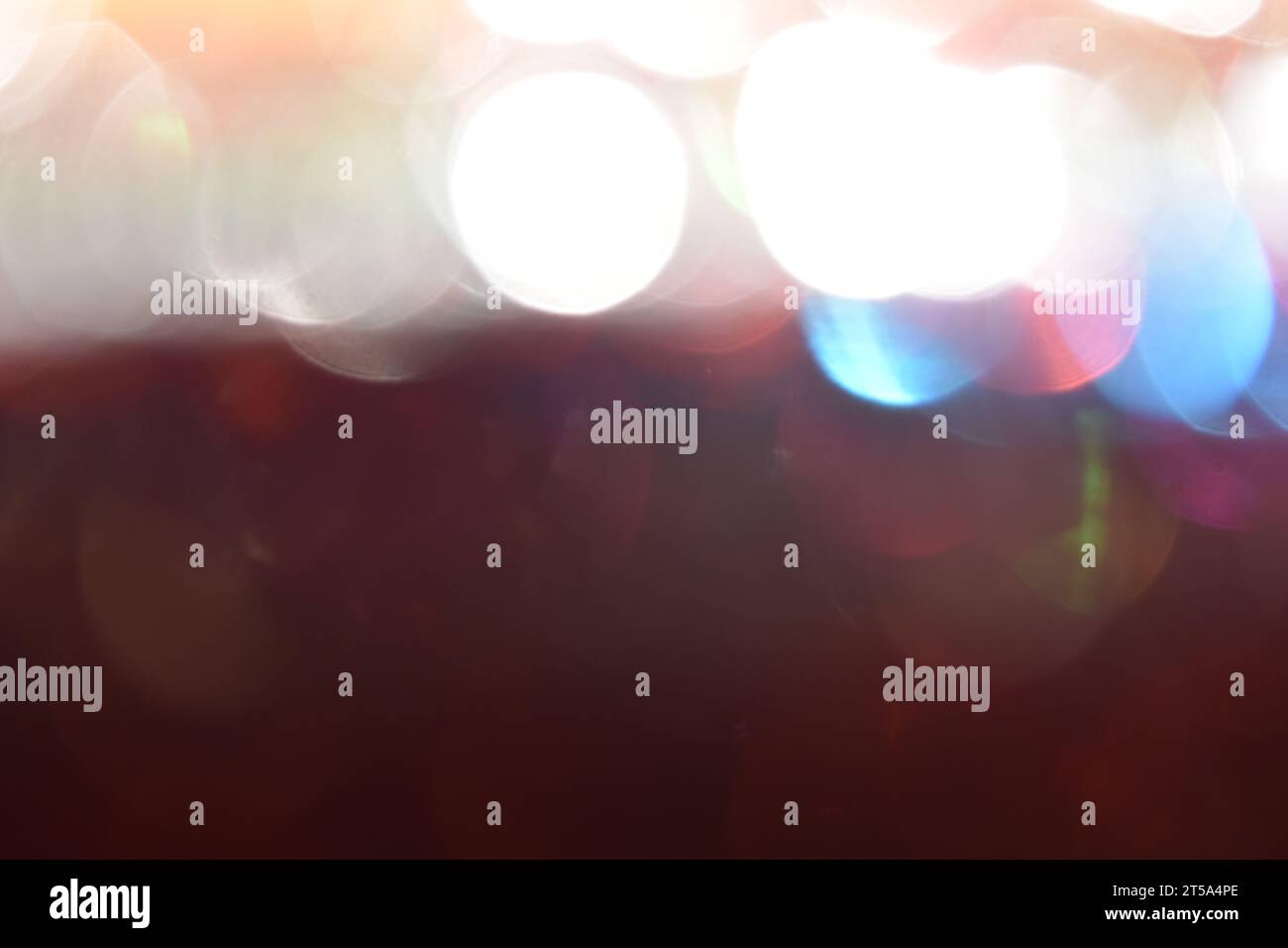 Light reflecting off of brightly colored tinsel, making a bokeh ...