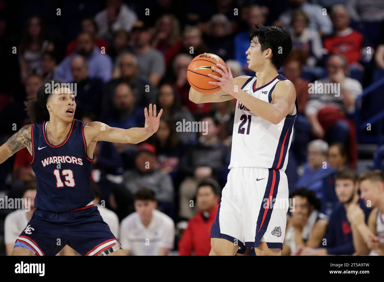 Gonzaga forward Jun Seok Yeo (21) controls the ball while defended by Lewis-Clark State forward ...