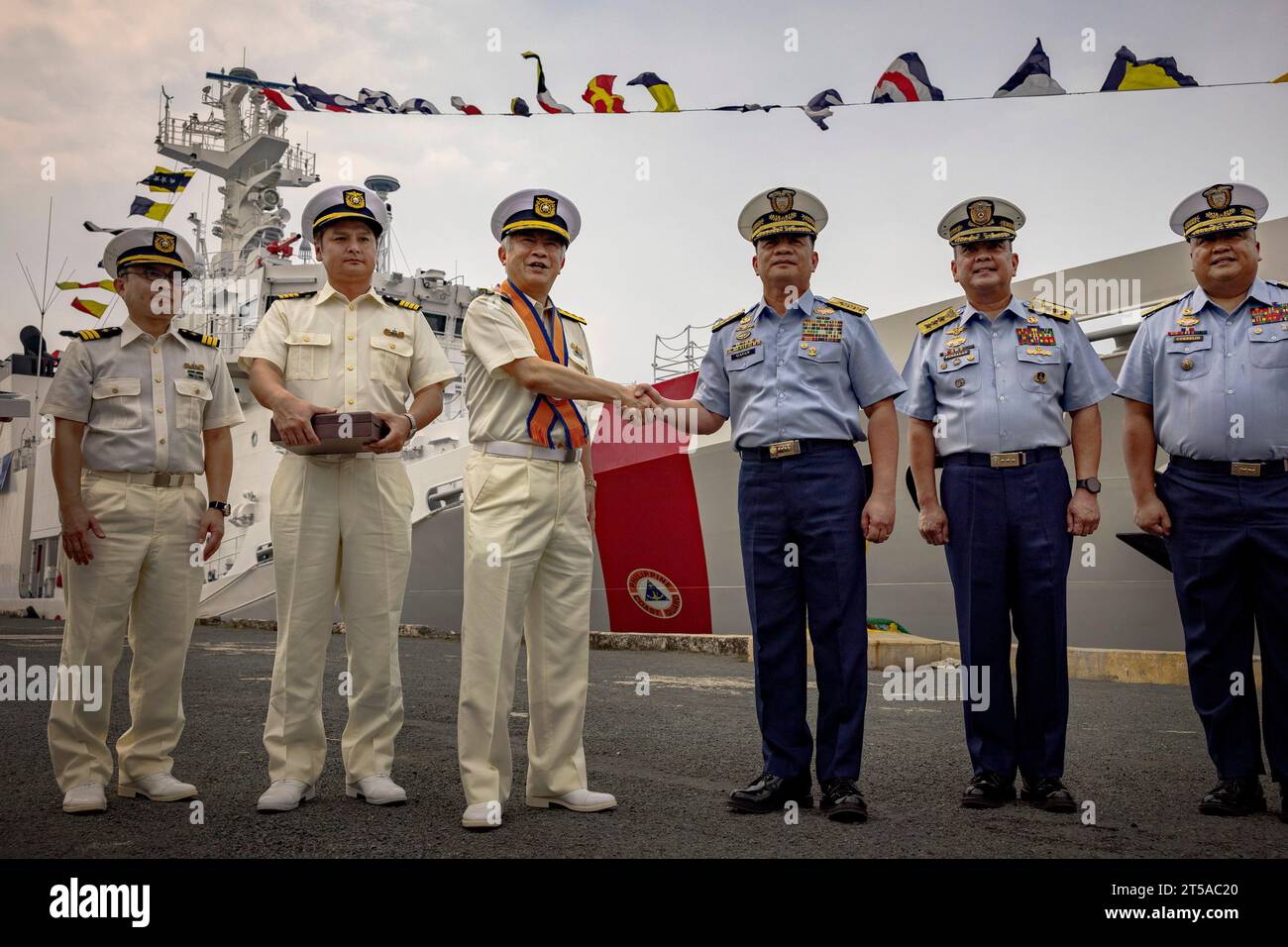 Japan Coast Guard Commandant Admiral Shohei Ishii, center left, and ...