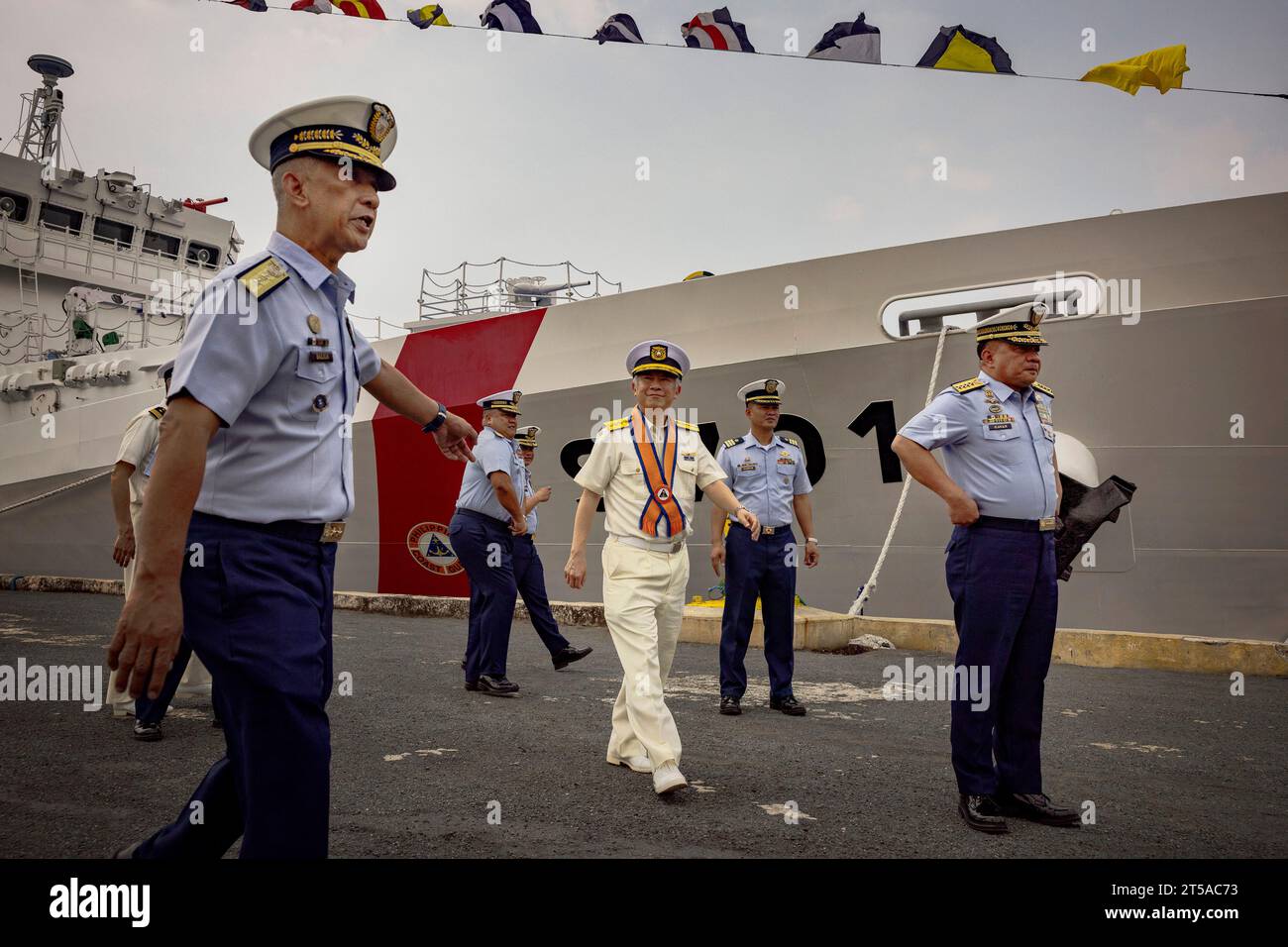 Japan Coast Guard Commandant Admiral Shohei Ishii, center, visits the ...