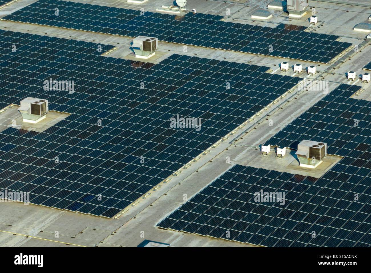 Aerial view of blue photovoltaic solar panels mounted on industrial ...