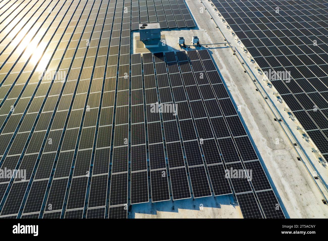 Aerial view of blue photovoltaic solar panels mounted on industrial ...