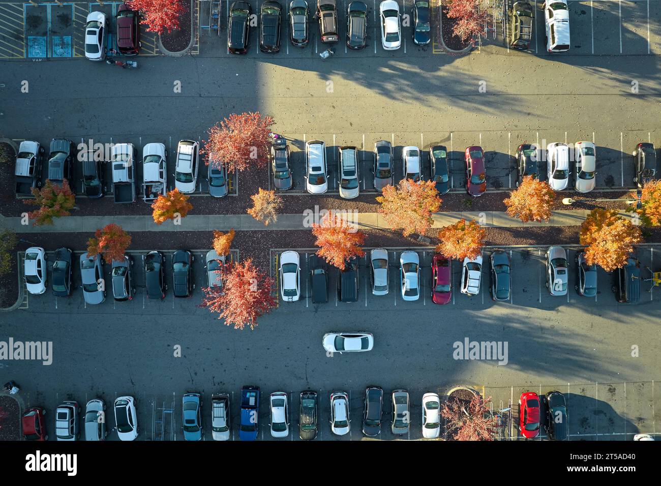 Aerial view of large parking lot with many parked colorful cars ...
