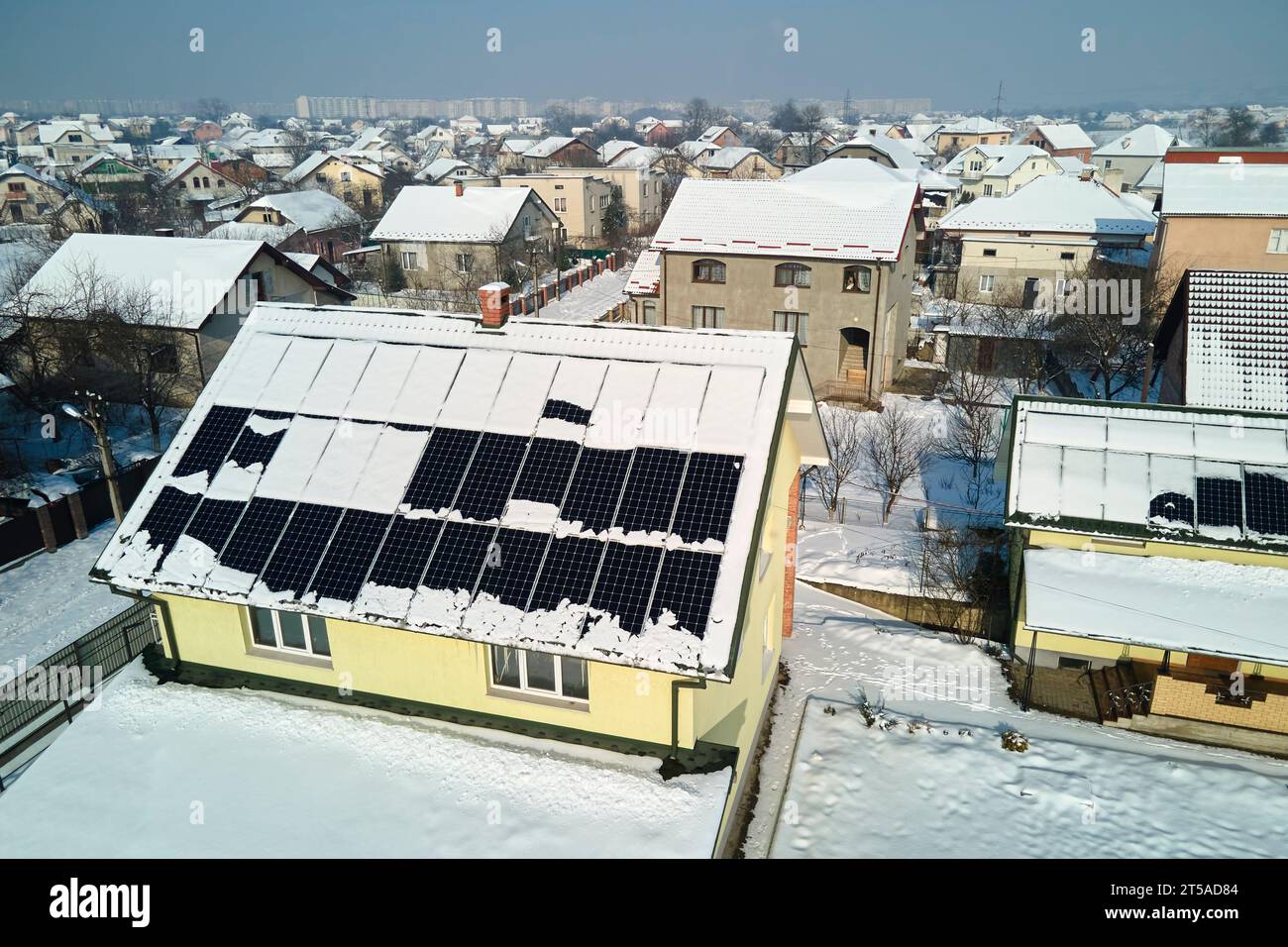 Aerial view of snow melting from covered solar photovoltaic panels ...