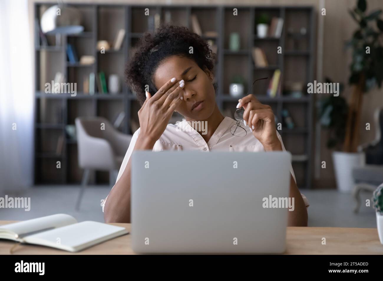 African gen Z student girl tired of studying at computer Stock Photo ...
