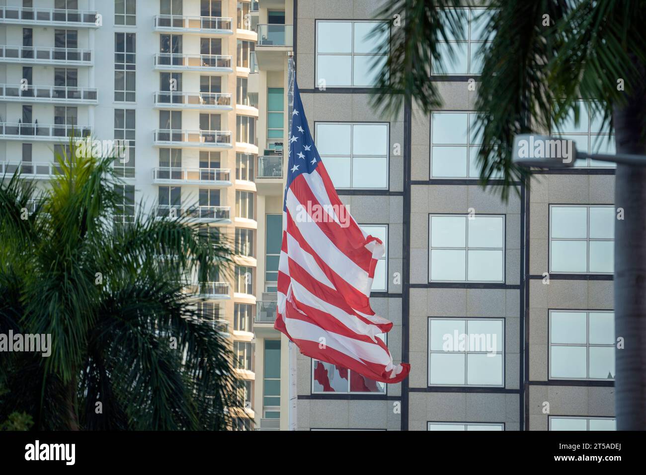 American flag waving in front of Miami skyline. Aerial view of USA ...