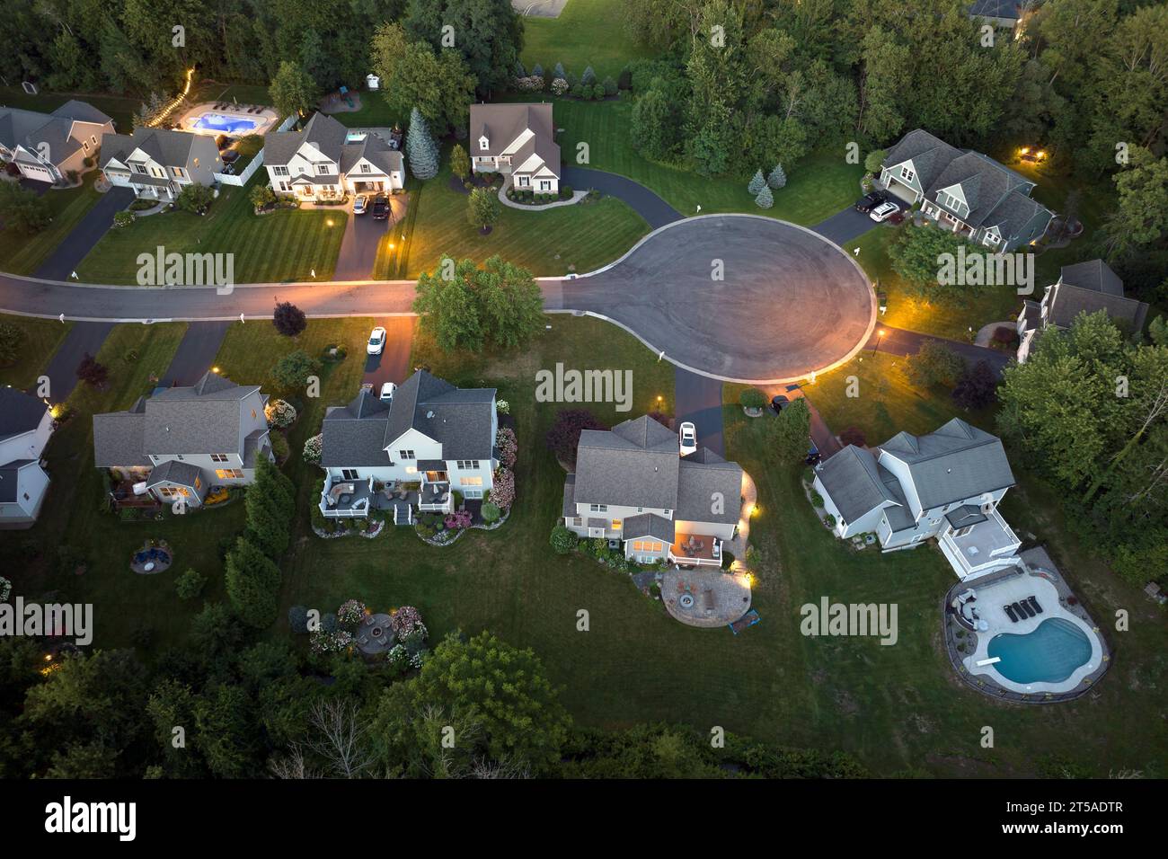 Cul de sac street dead end at night and private residential houses in ...
