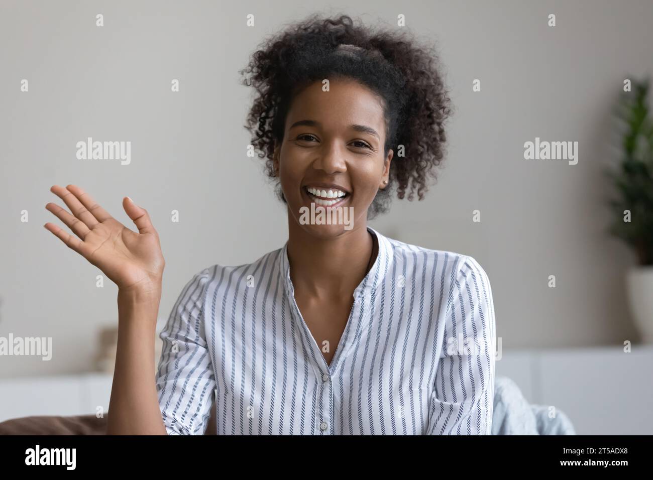 Happy millennial Black girl, young woman waving hello at webcam Stock ...