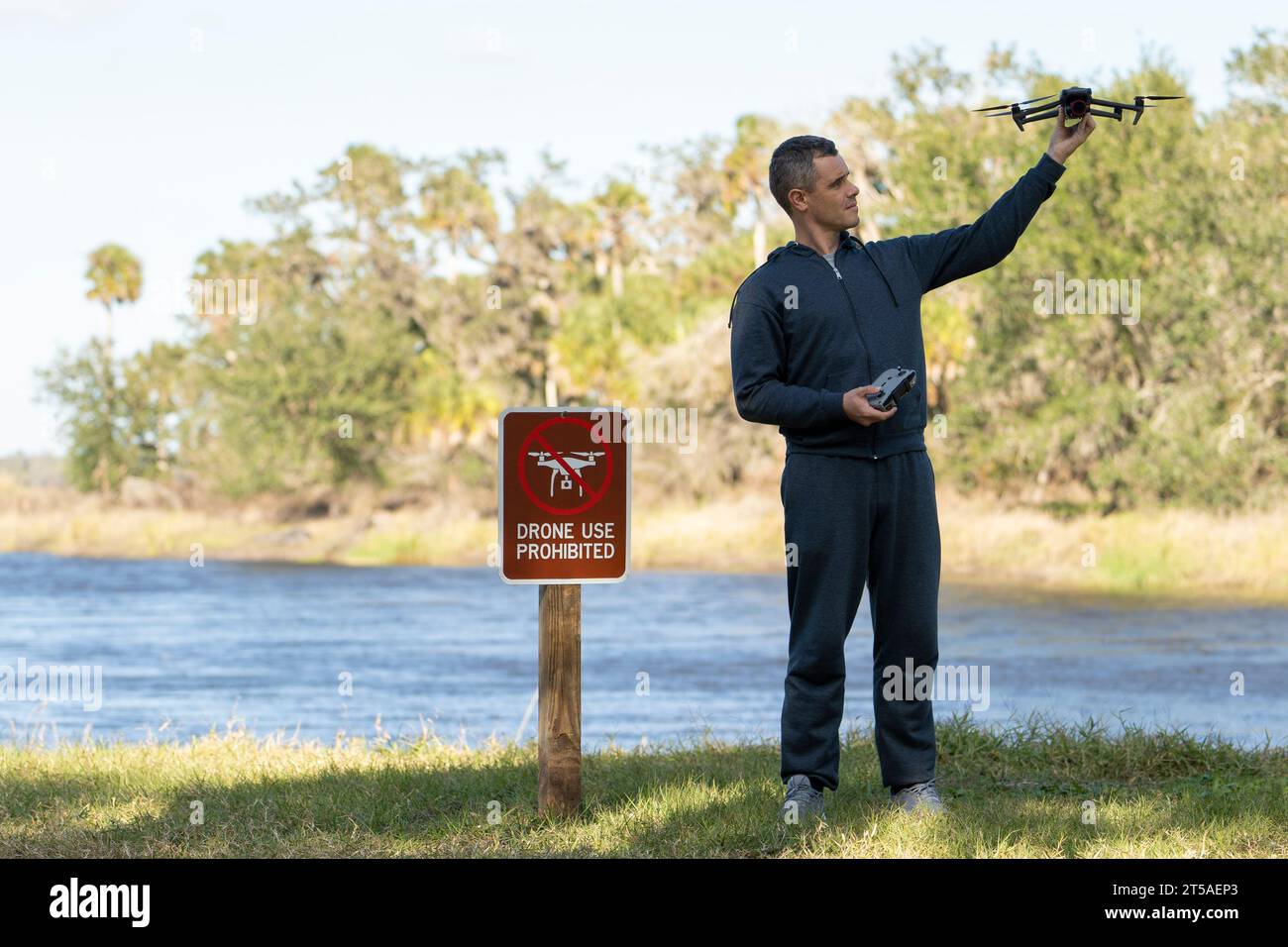 Operator is preparing to fly his quadcopter in national park no drone ...