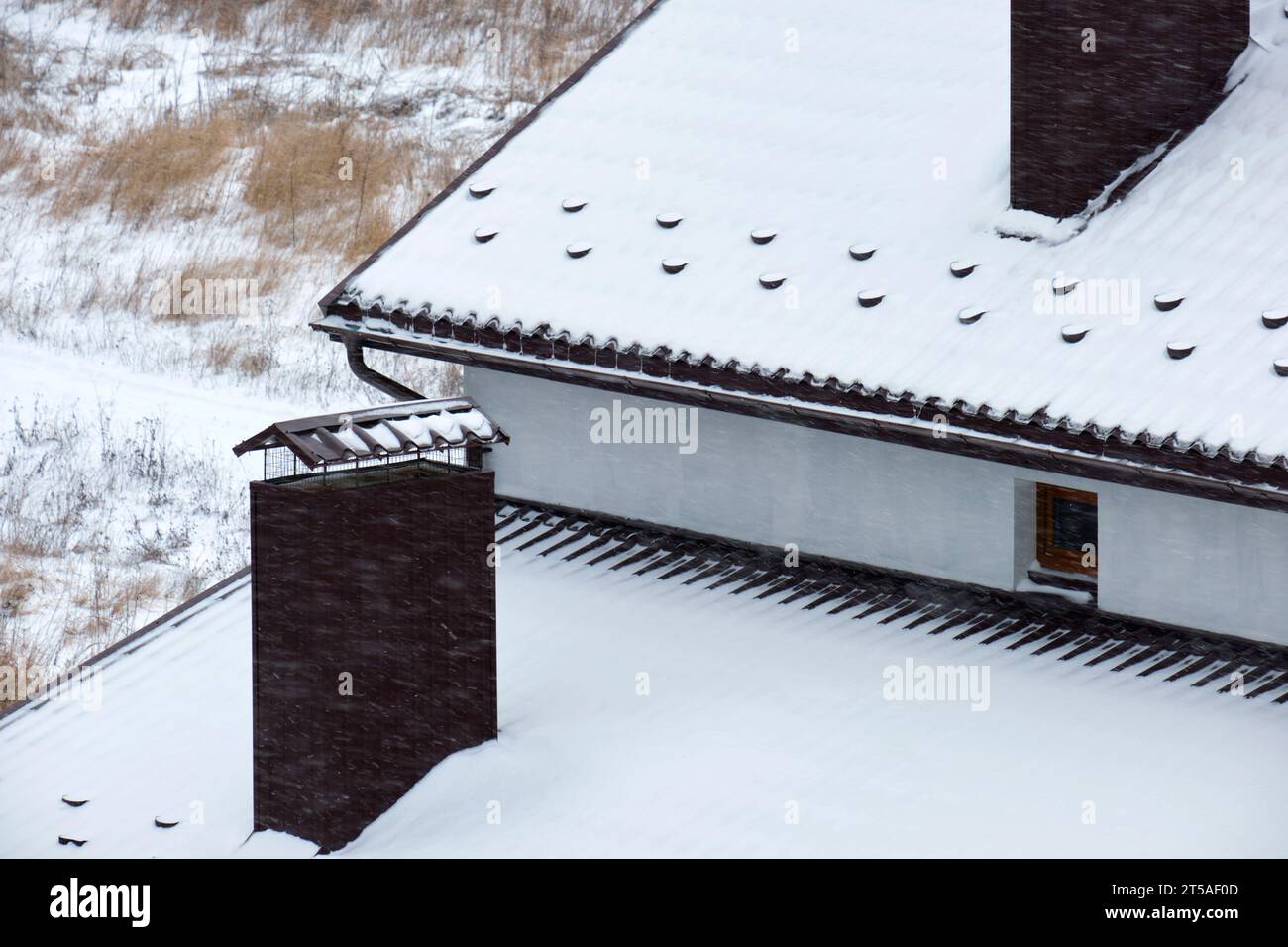 Snow guard for safety in winter on house roof top covered with ceramic ...