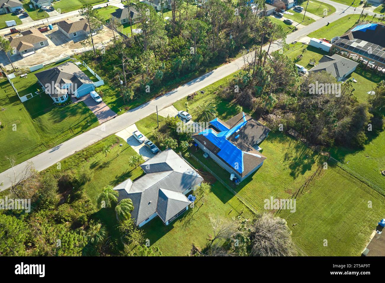 Top view of leaking house roof covered with protective tarp sheets ...