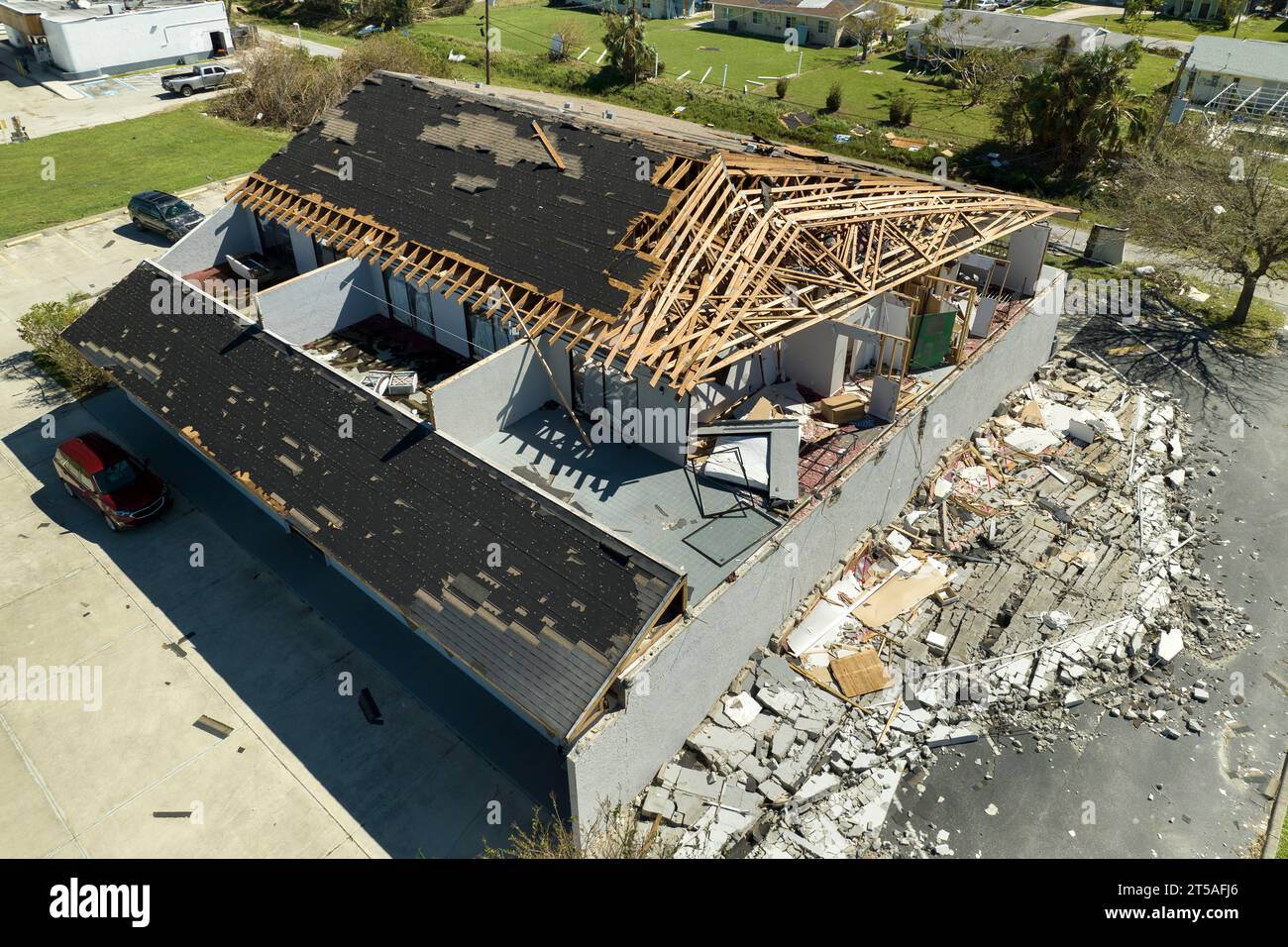Wind destroyed house roof and walls with missing asphalt shingles after ...