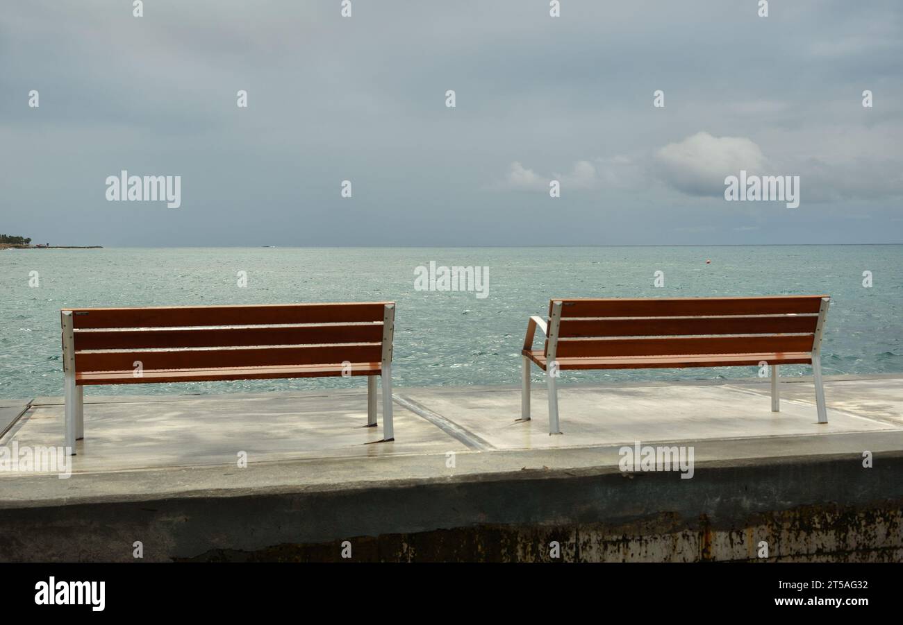 Two benches on the waterfront Stock Photo - Alamy
