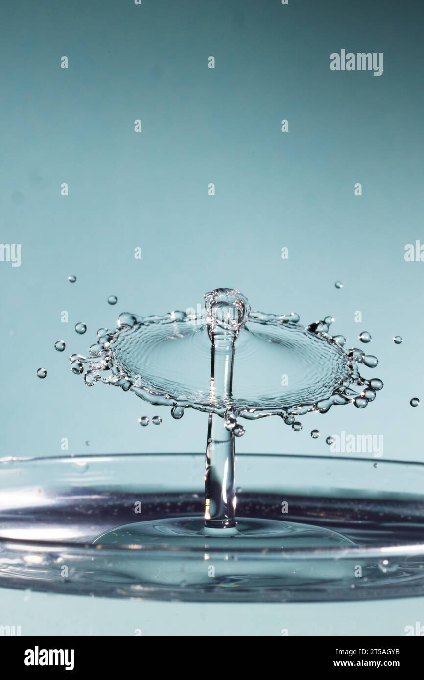 two drops of water collide and cause a splash with crown and spikes ...