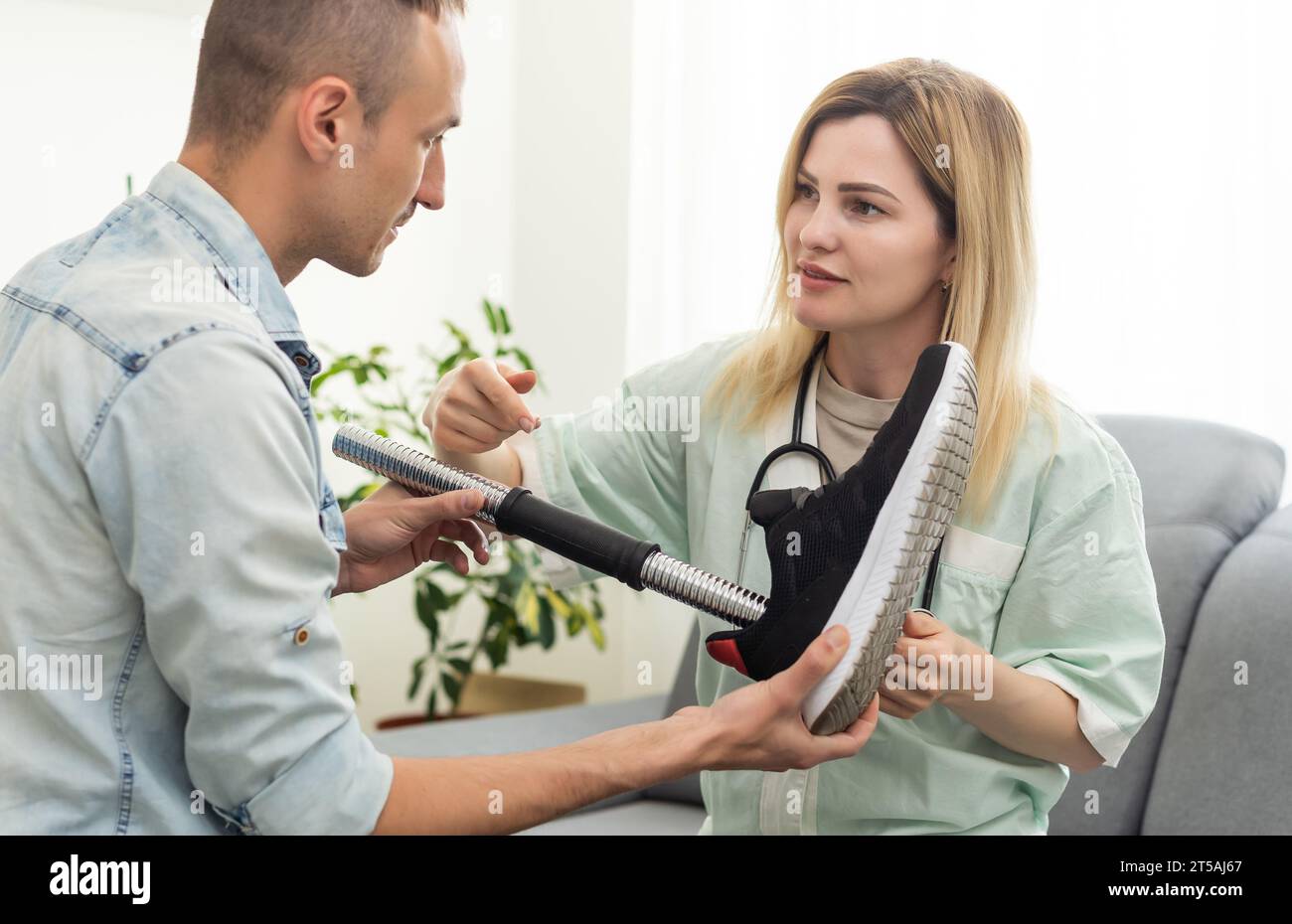 Modern Hospital Physical Therapy: Doctor Uses Tablet Computer, Helps ...