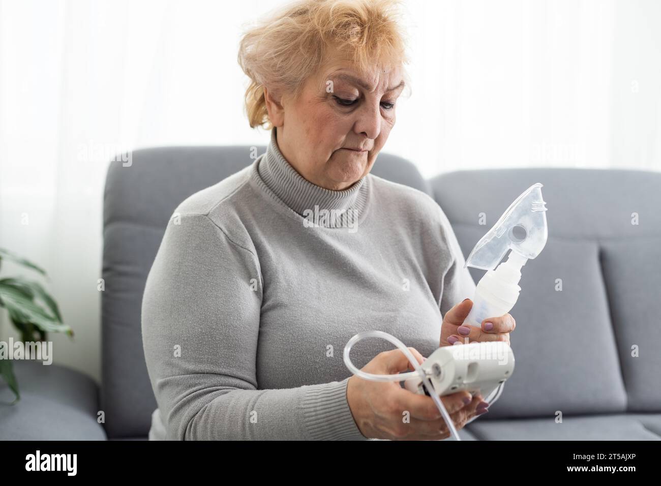 Sick senior woman has a viral infection or flu, labored breathing ...