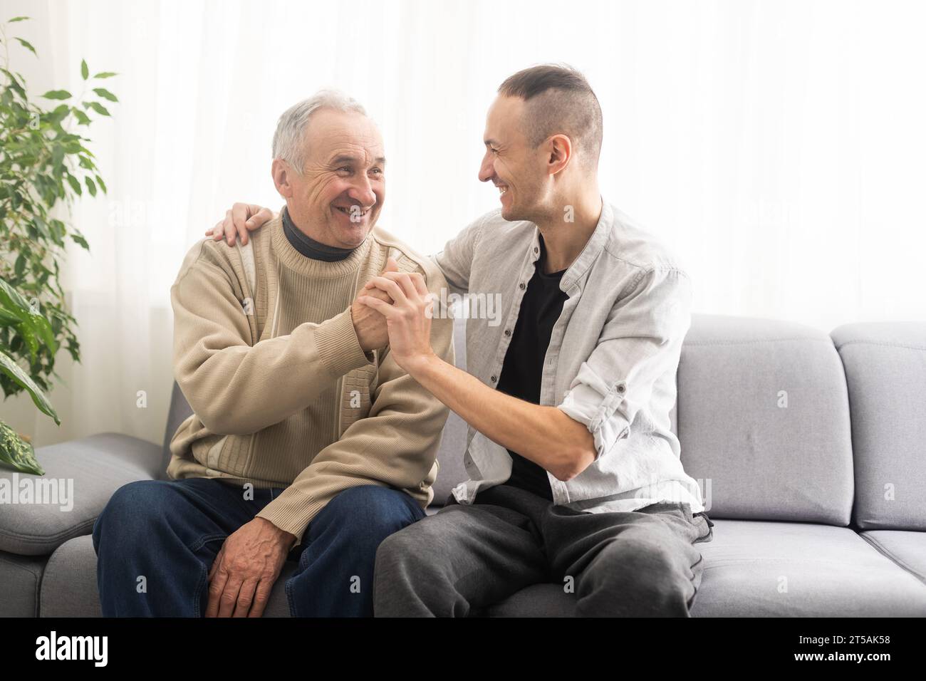 Happy two generations male family old senior mature father and smiling ...