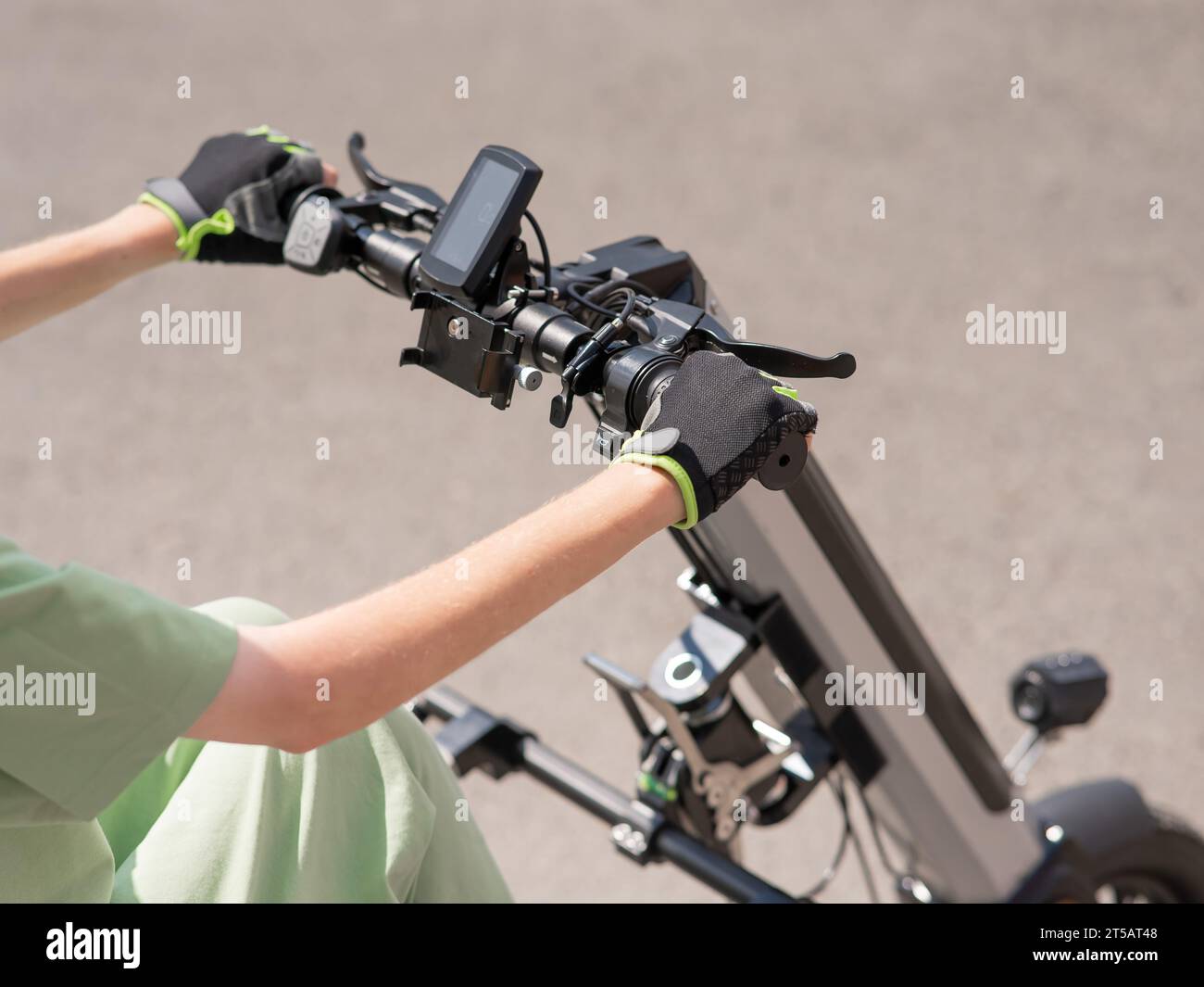 A woman controls a wheelchair using a special manual device. Close-up ...