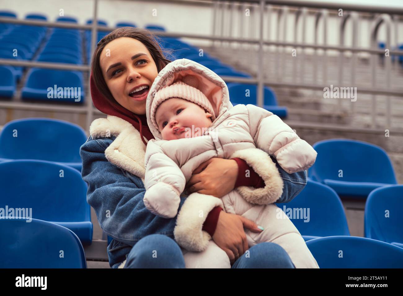 A young mother and her newborn daughter at the stadium Stock Photo - Alamy