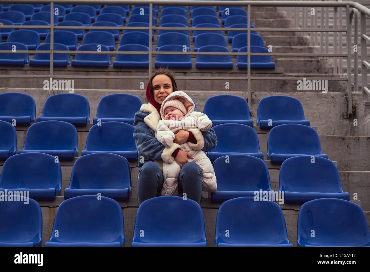 A young mother and her newborn daughter at the stadium Stock Photo - Alamy