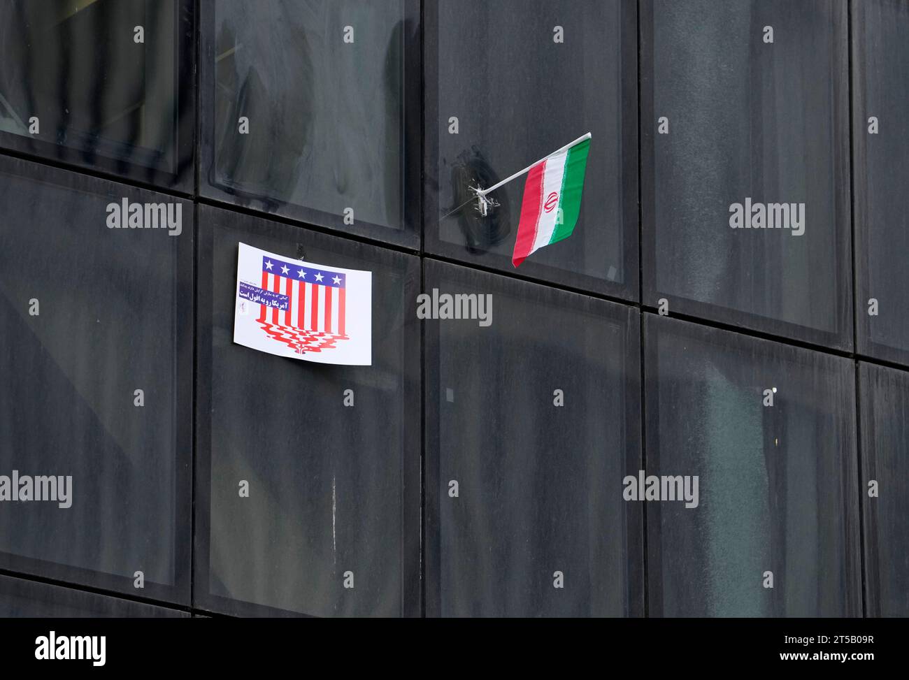 An Iranian flag and an anti-U.S. placard placed on the window of a ...