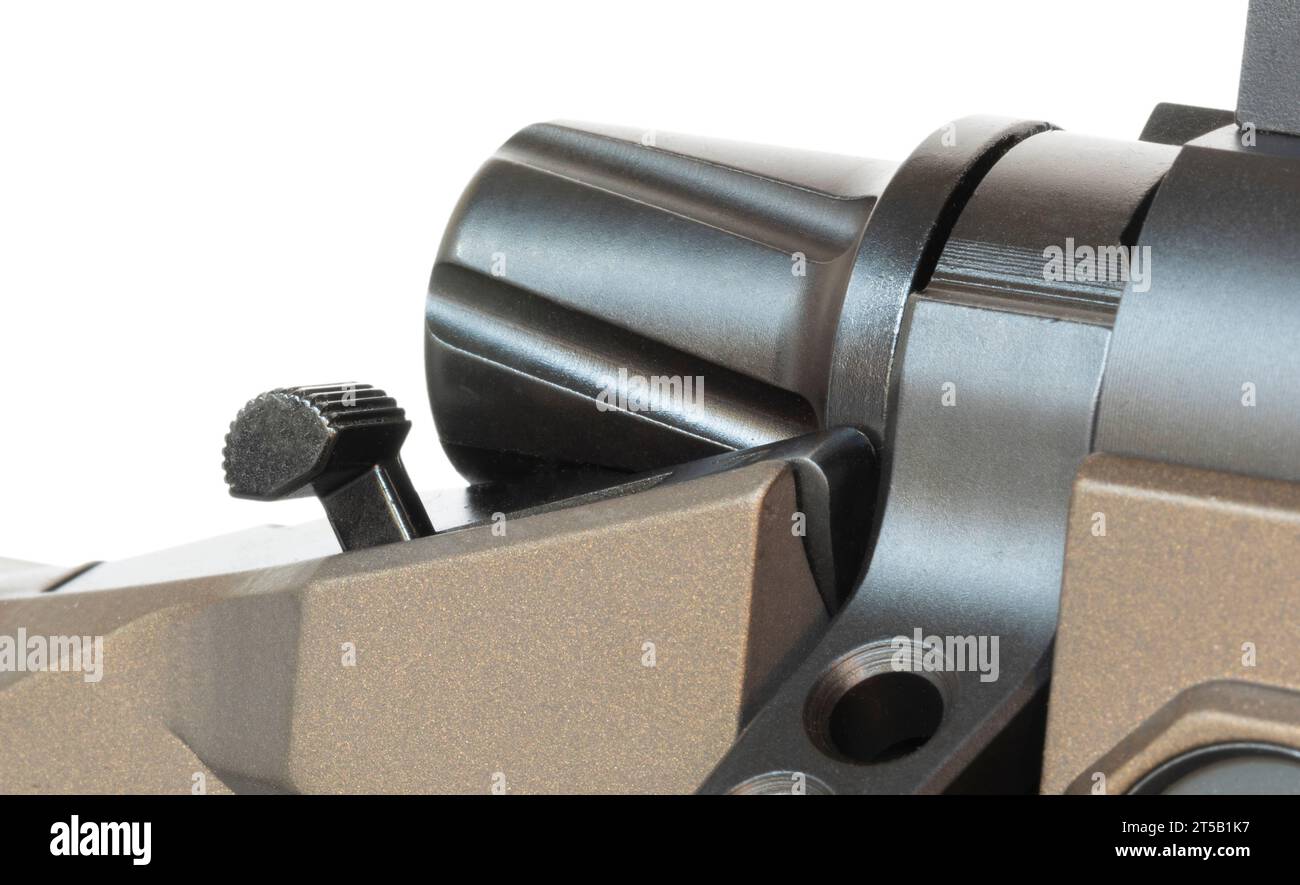 Safety on a bolt action rifle with bronze metallic finish that is ...