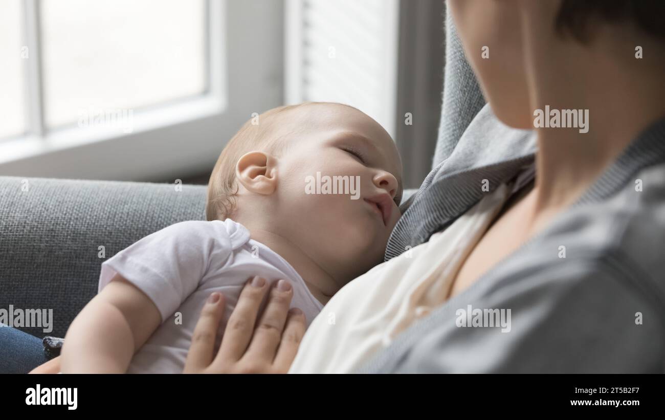Little baby falling asleep in loving mothers hands Stock Photo - Alamy