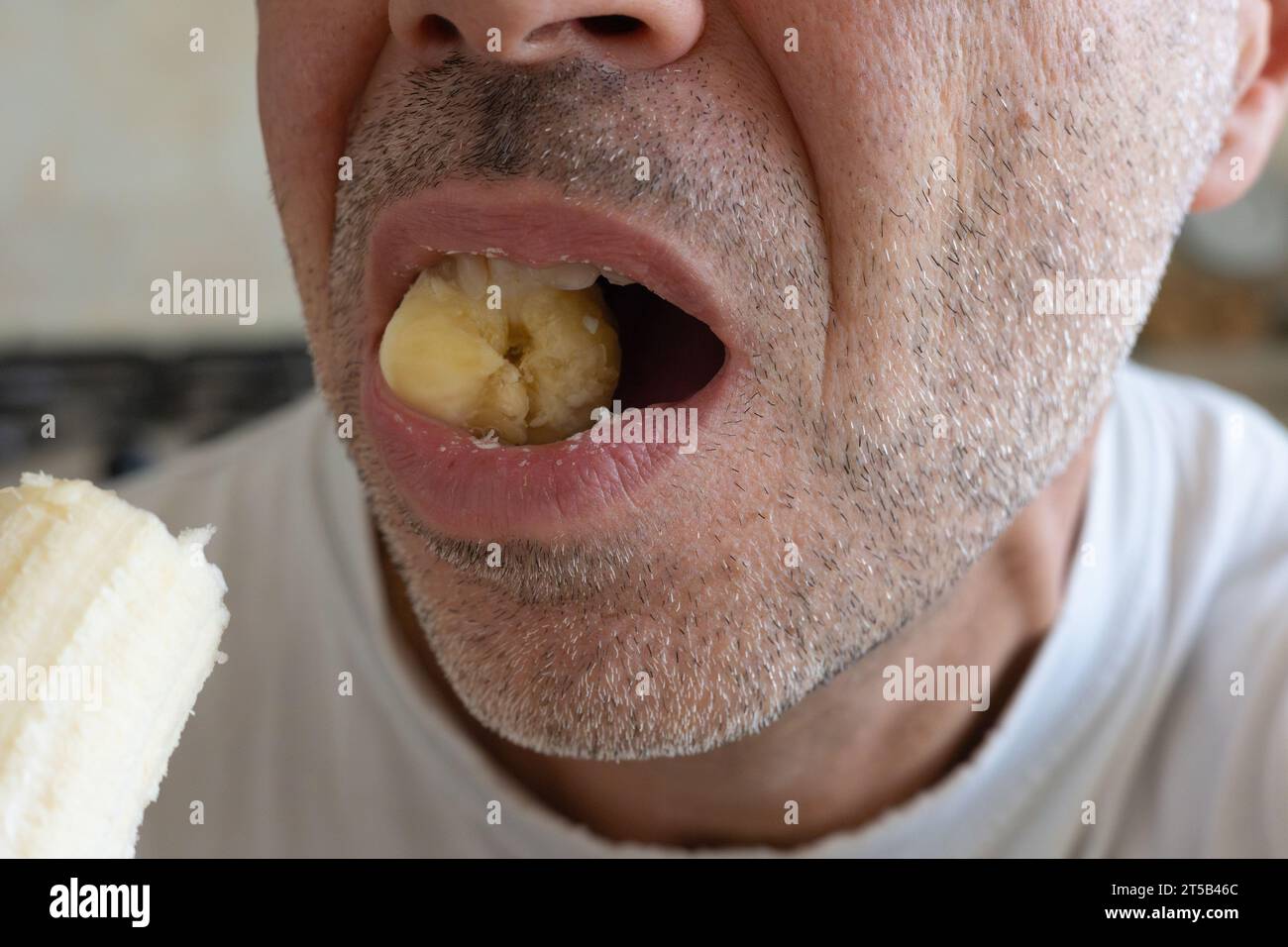 Detail of a Man's Mouth Biting a Banana Stock Photo - Alamy
