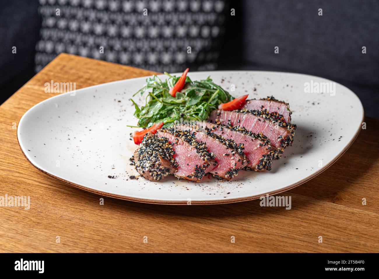 Tuna tataki in sesame with quinoa and spinach. Healthy food, close-up ...