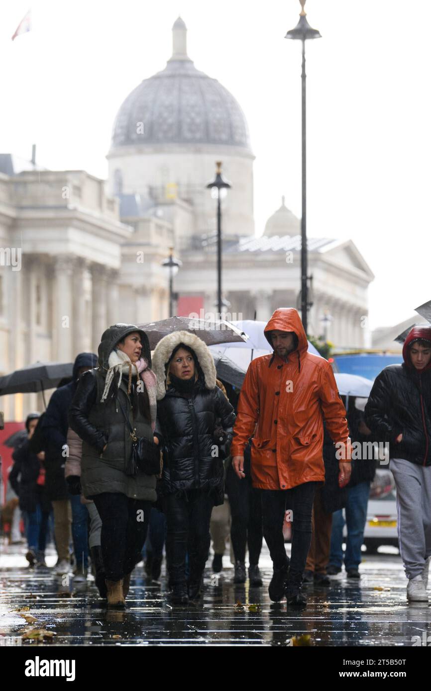 People in the wet weather in Trafalgar Square, London. The threat of ...