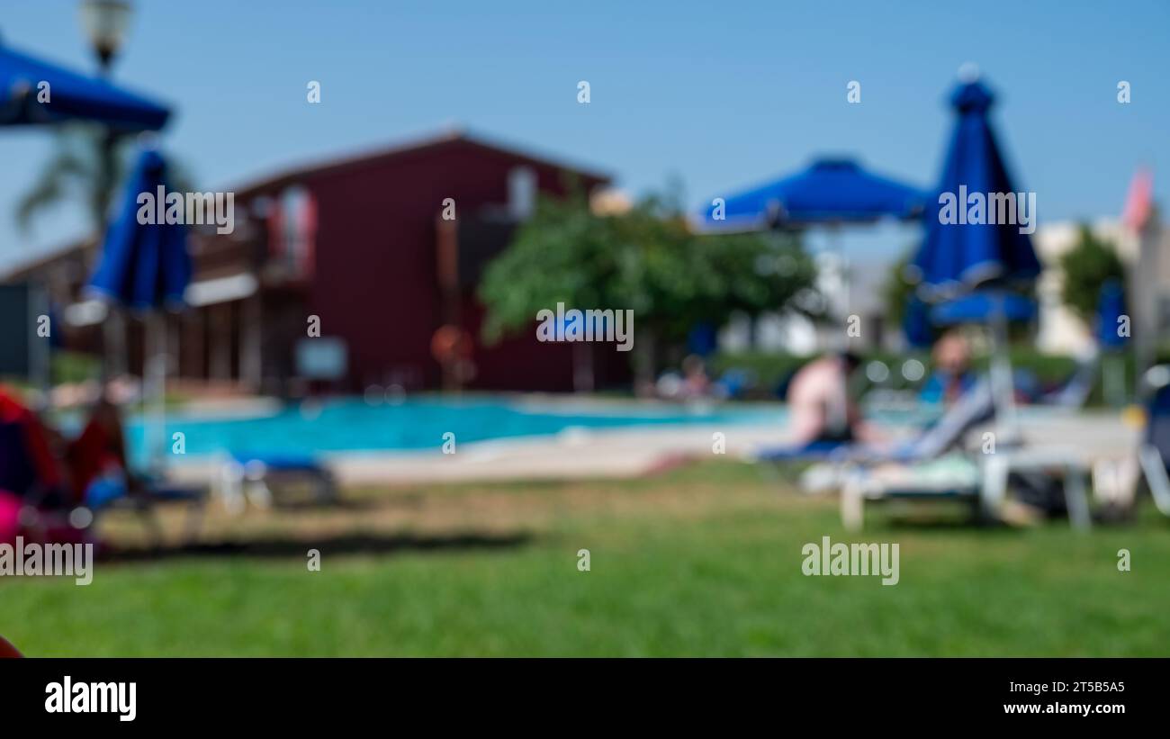 Blurred shot footage showing people relaxing and sunbathing on poolside ...