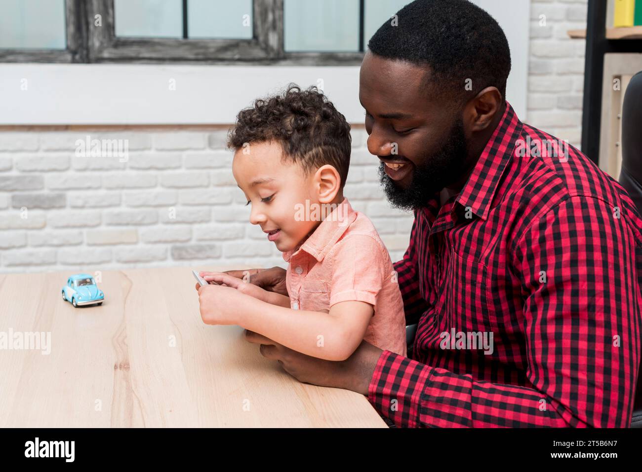 Black father son using tablet Stock Photo - Alamy