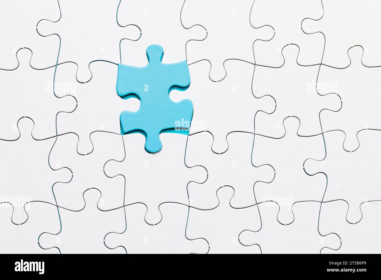 Blue piece puzzle connected with white piece backdrop Stock Photo - Alamy