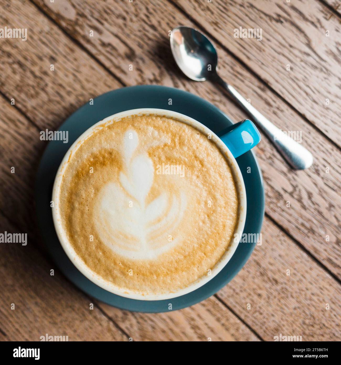 Close up latte coffee with creative latte art wooden textured ...