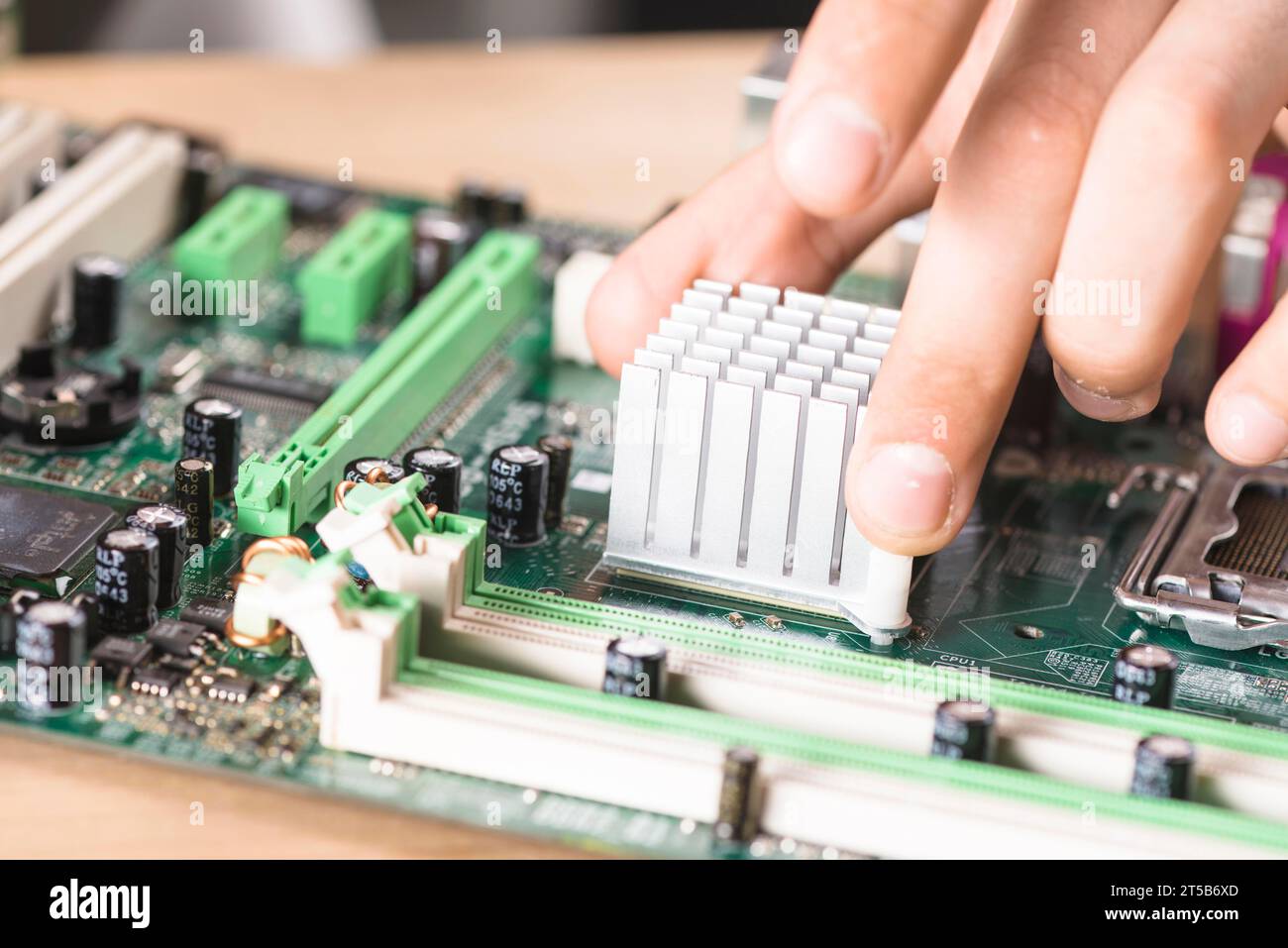Close up male technician hand s installing heatsink computer main board Stock Photo - Alamy