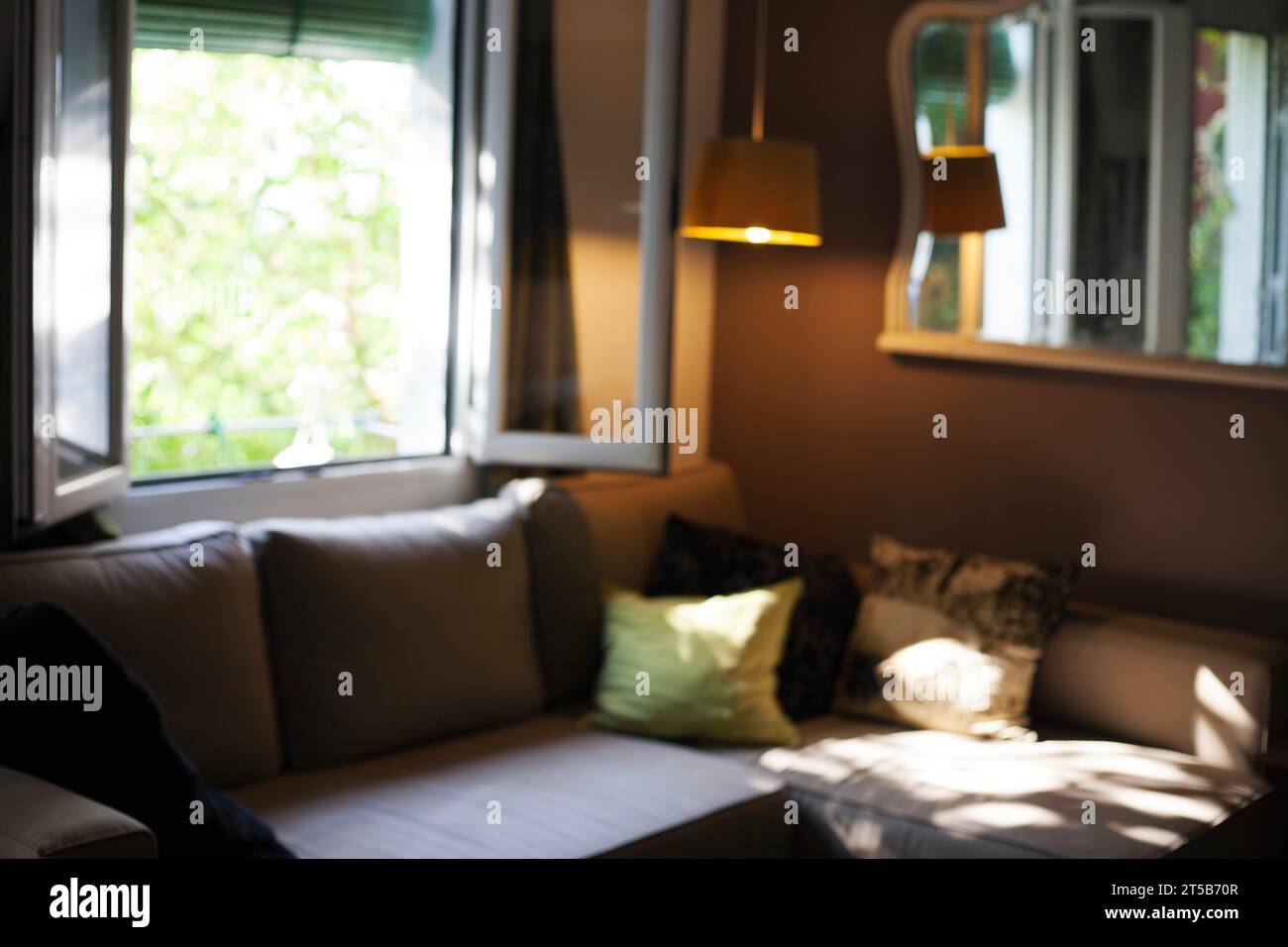 Comfortable living room with sofa open window Stock Photo - Alamy