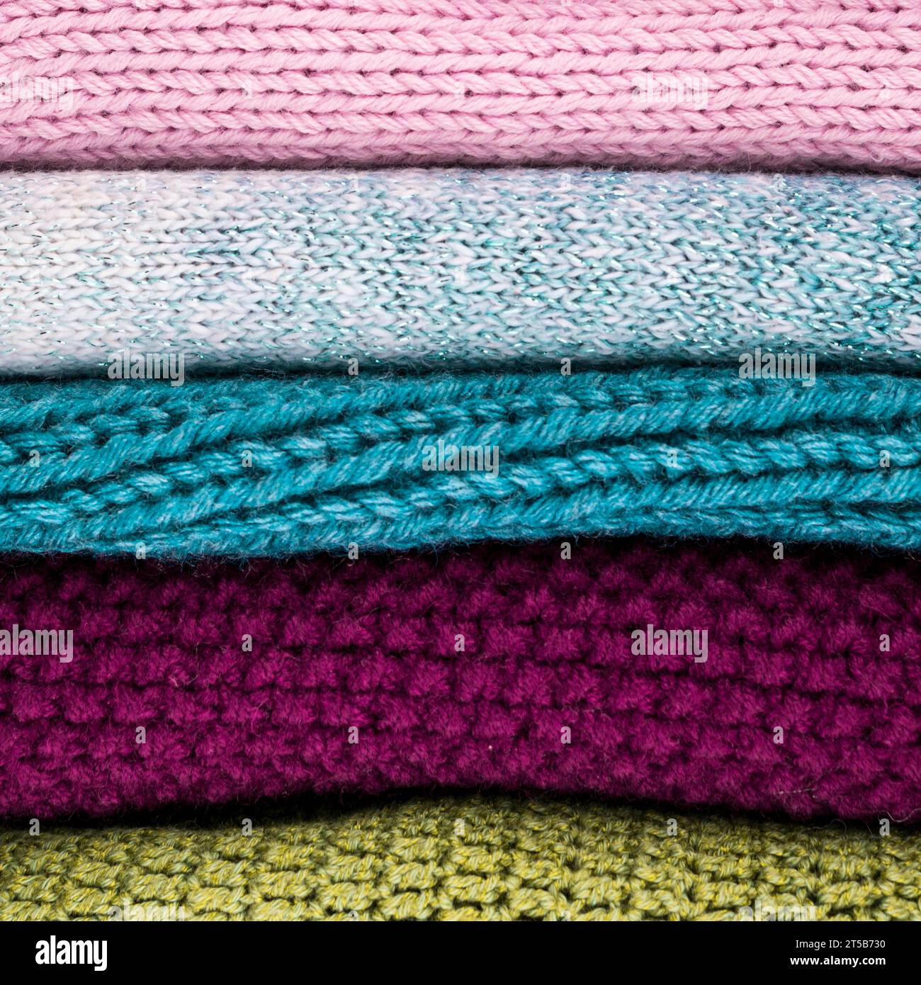 Crocheted colorful wool clothes stacked Stock Photo - Alamy
