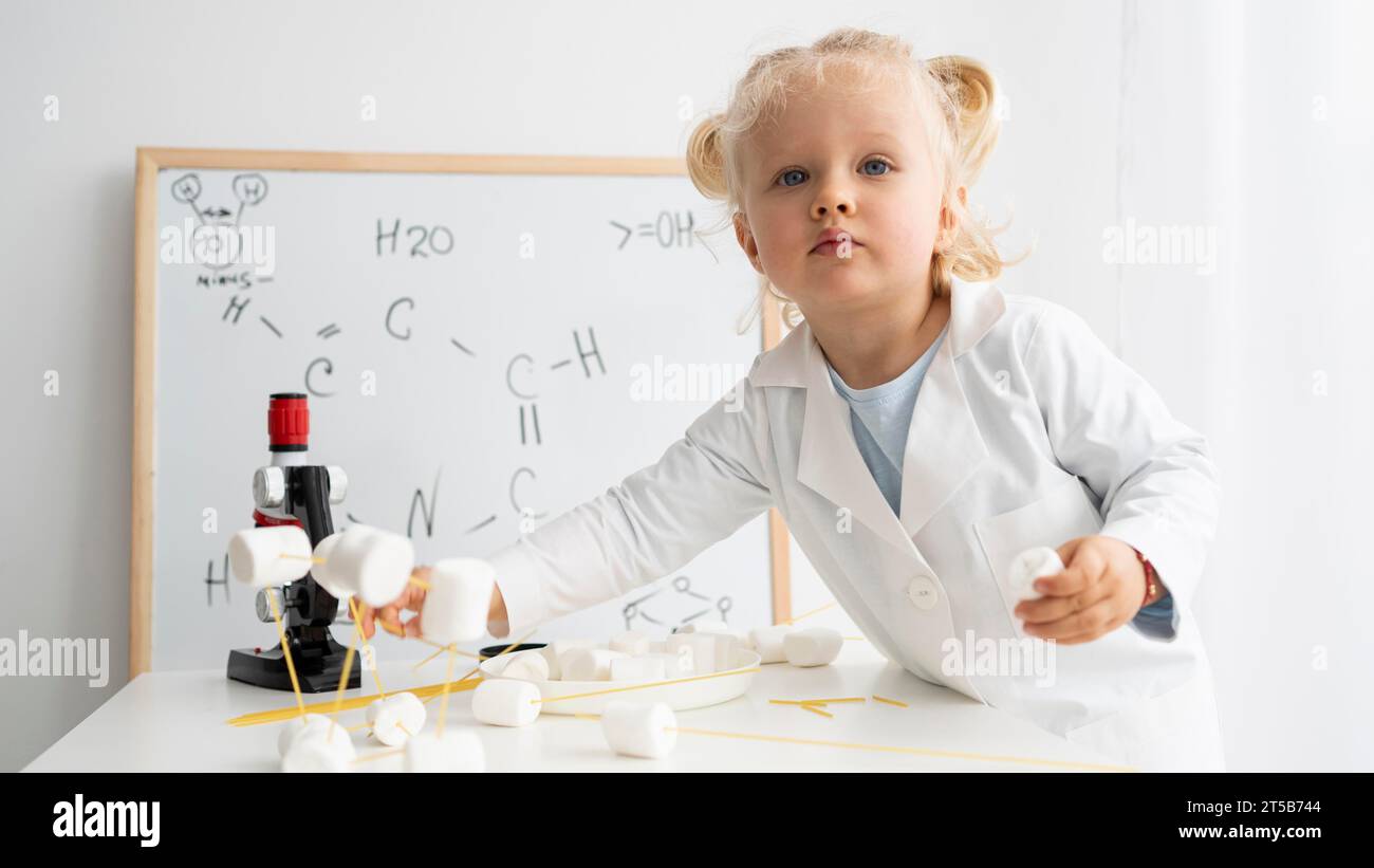 Cute toddler learning about science with whiteboard microscope Stock ...